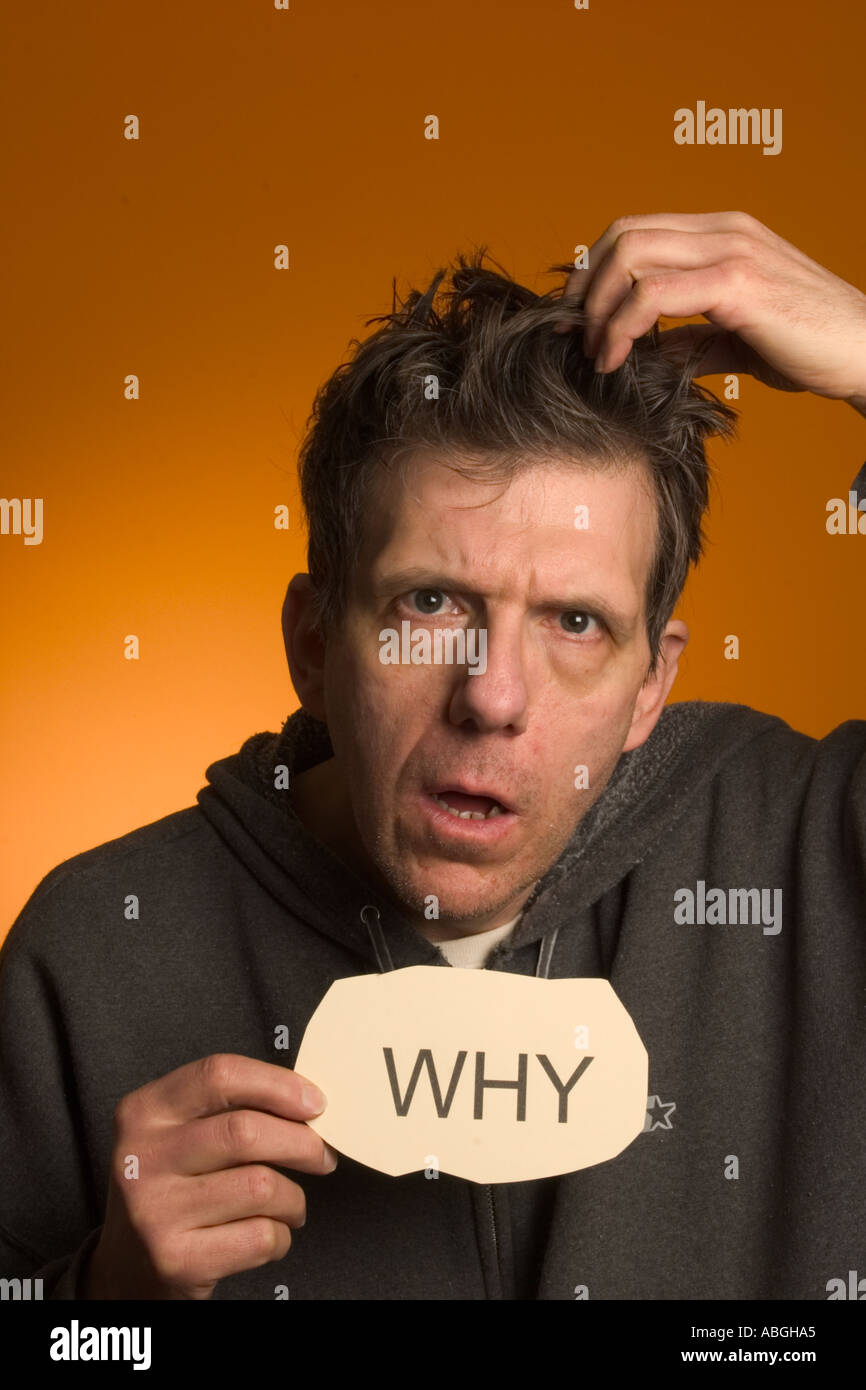 Scary looking man holding a sign reading "Why Stock Photo - Alamy