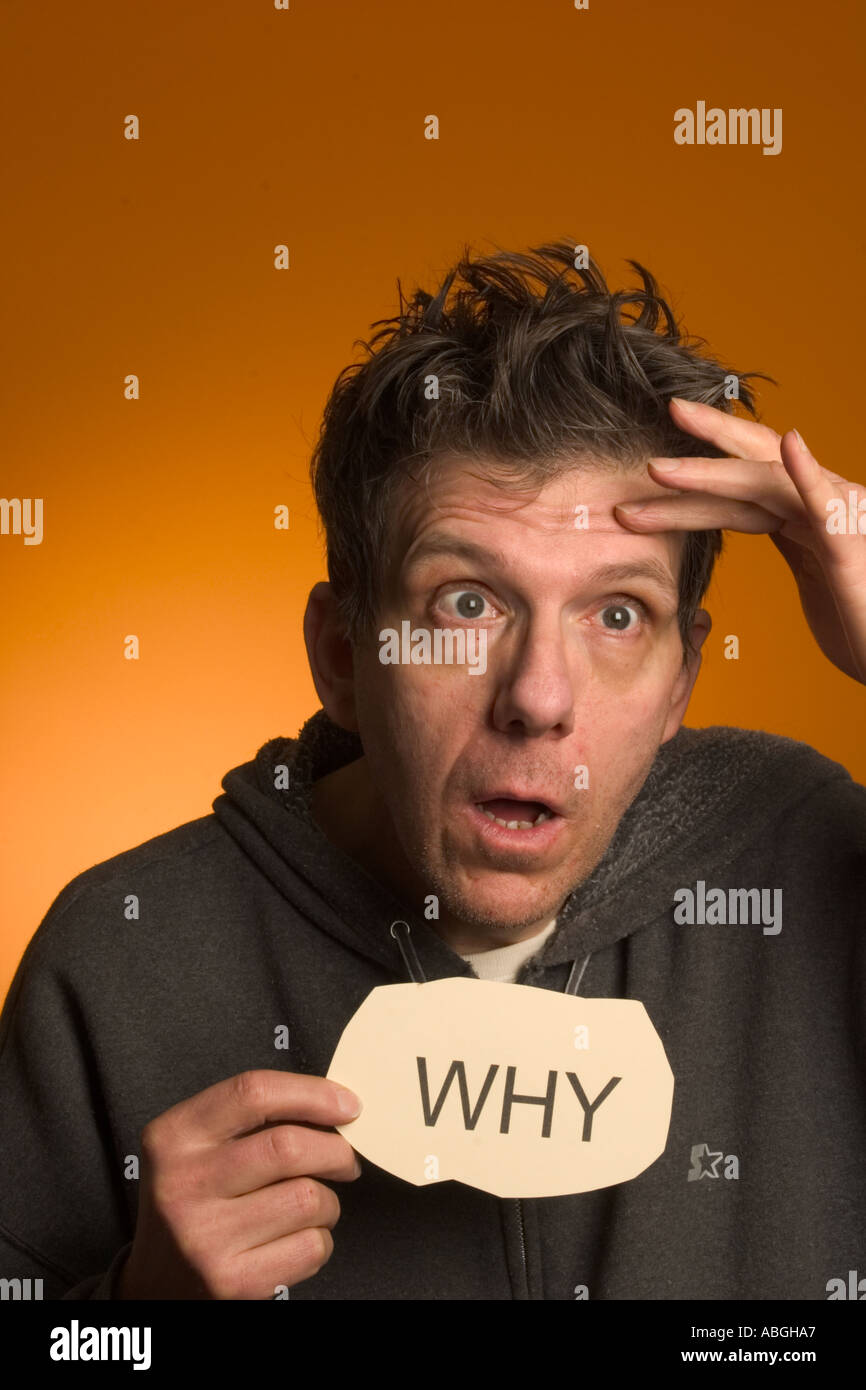 Scary looking man holding a sign reading "Why Stock Photo - Alamy