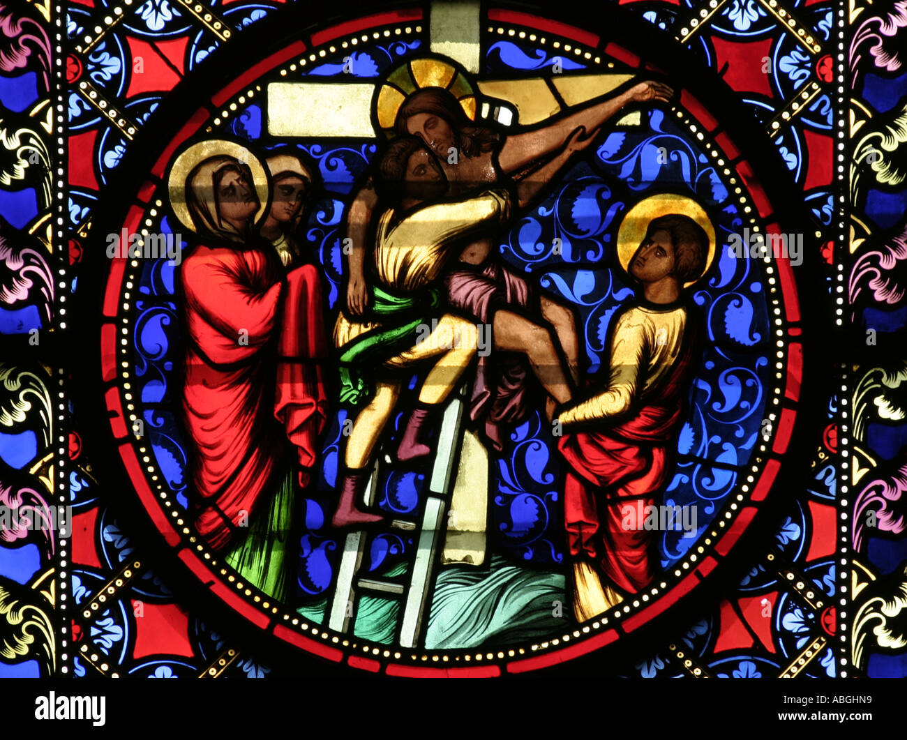 Detail from stained glass window showing Jesus being removed from the ...