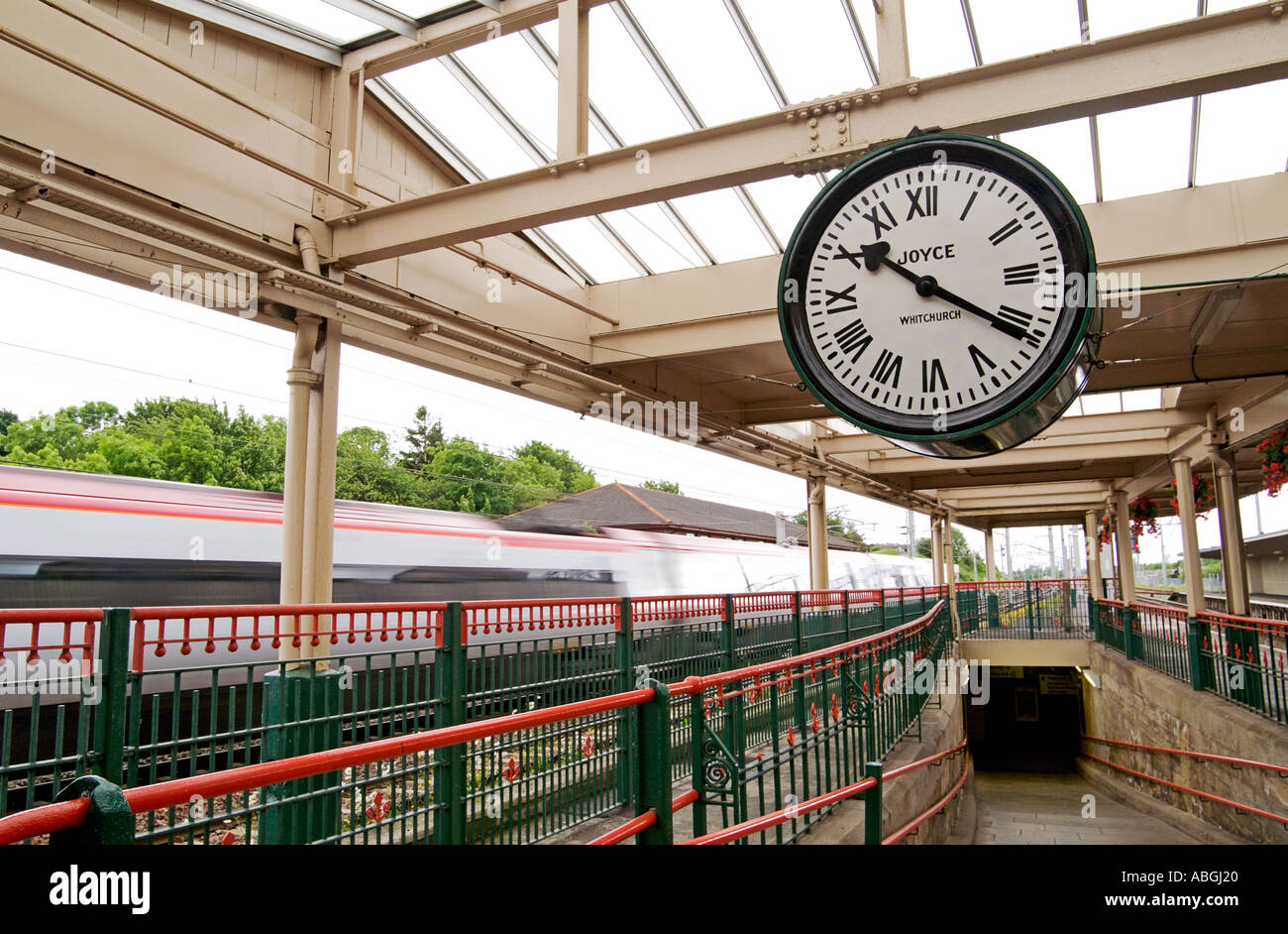 Railway station clock and passing train at Carnforth Lancashire England ...