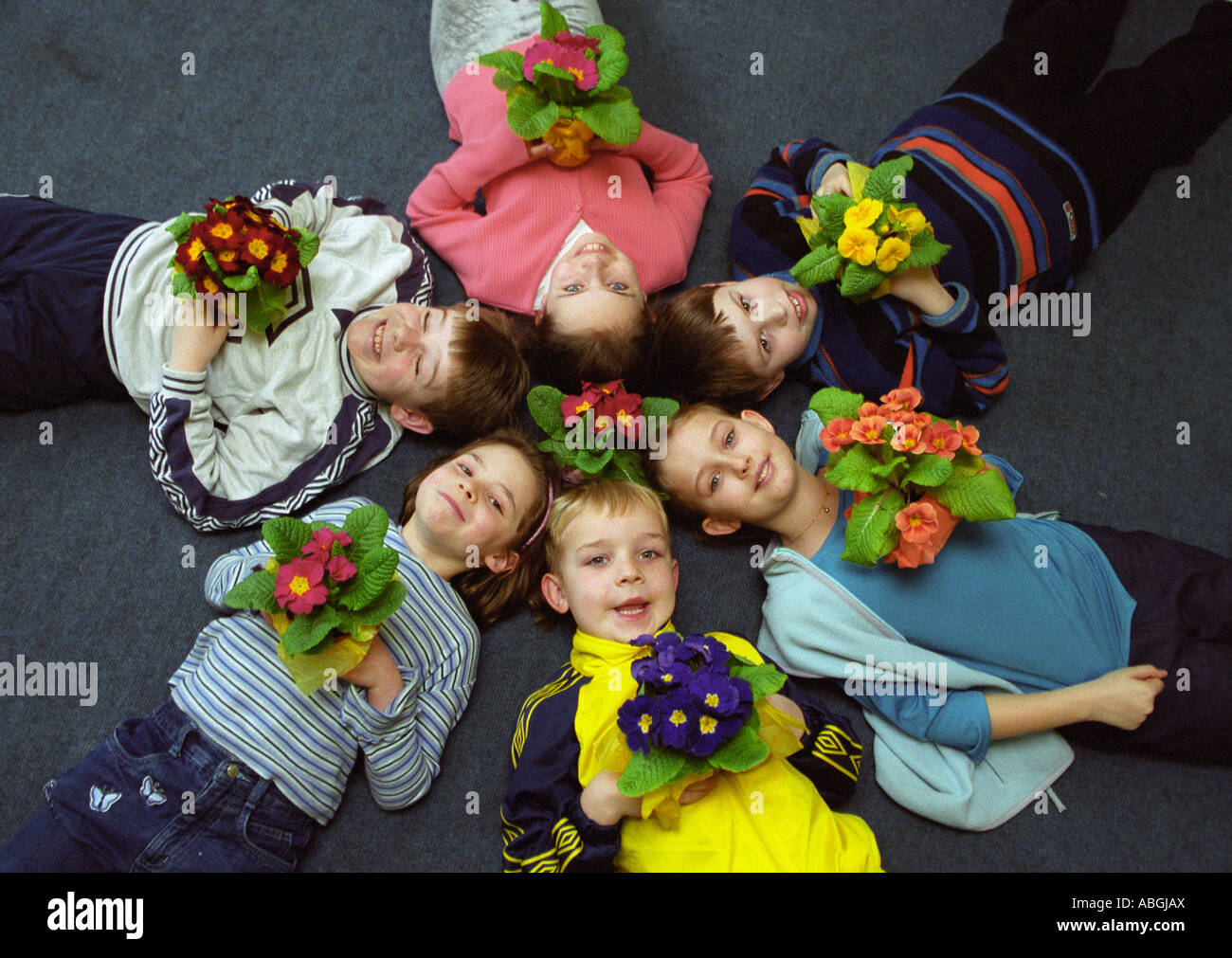 Pupils in School Playground holding Flowers they grew themselves Stock ...