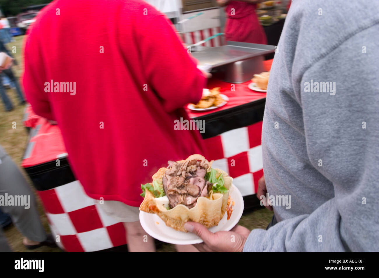 Man carrying a beef dinner at a Connecticut USA fair Stock Photo - Alamy