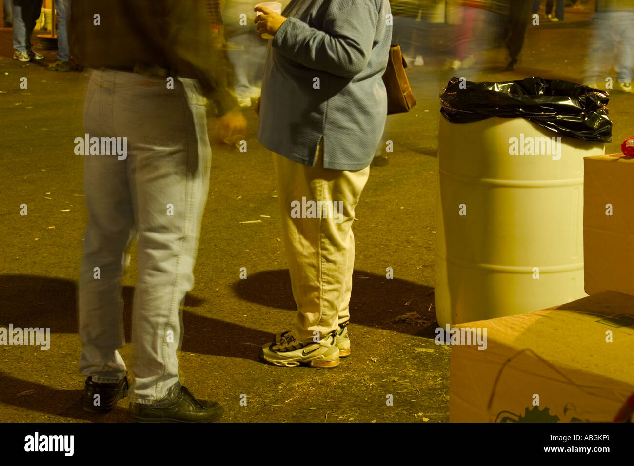 Couple at a Connecticut USA fair standing next to a trash can Stock ...