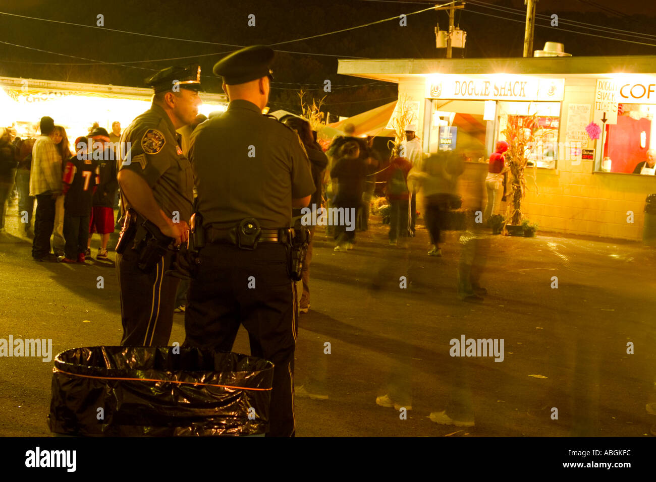 Police officers at a fair at night keeping an eye on things Stock Photo ...