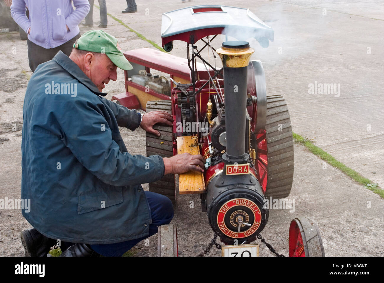 Man cleaning and maintaining miniature steam traction engine Stock ...