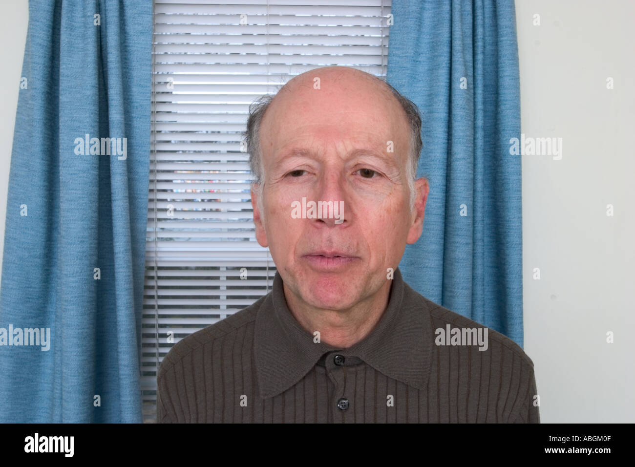 Middle age balding man standing and talking in his living room Model ...