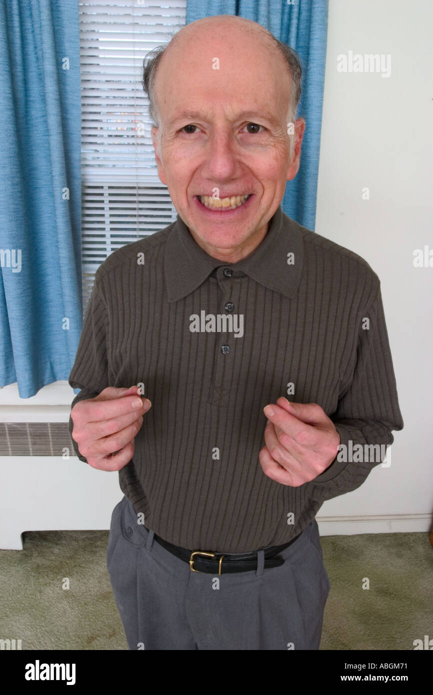 Middle age balding man standing and talking in his living room Model ...