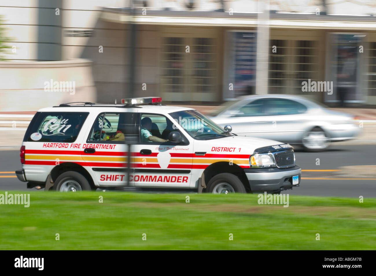 Fire department s Shift Commander car driving on a city street in ...