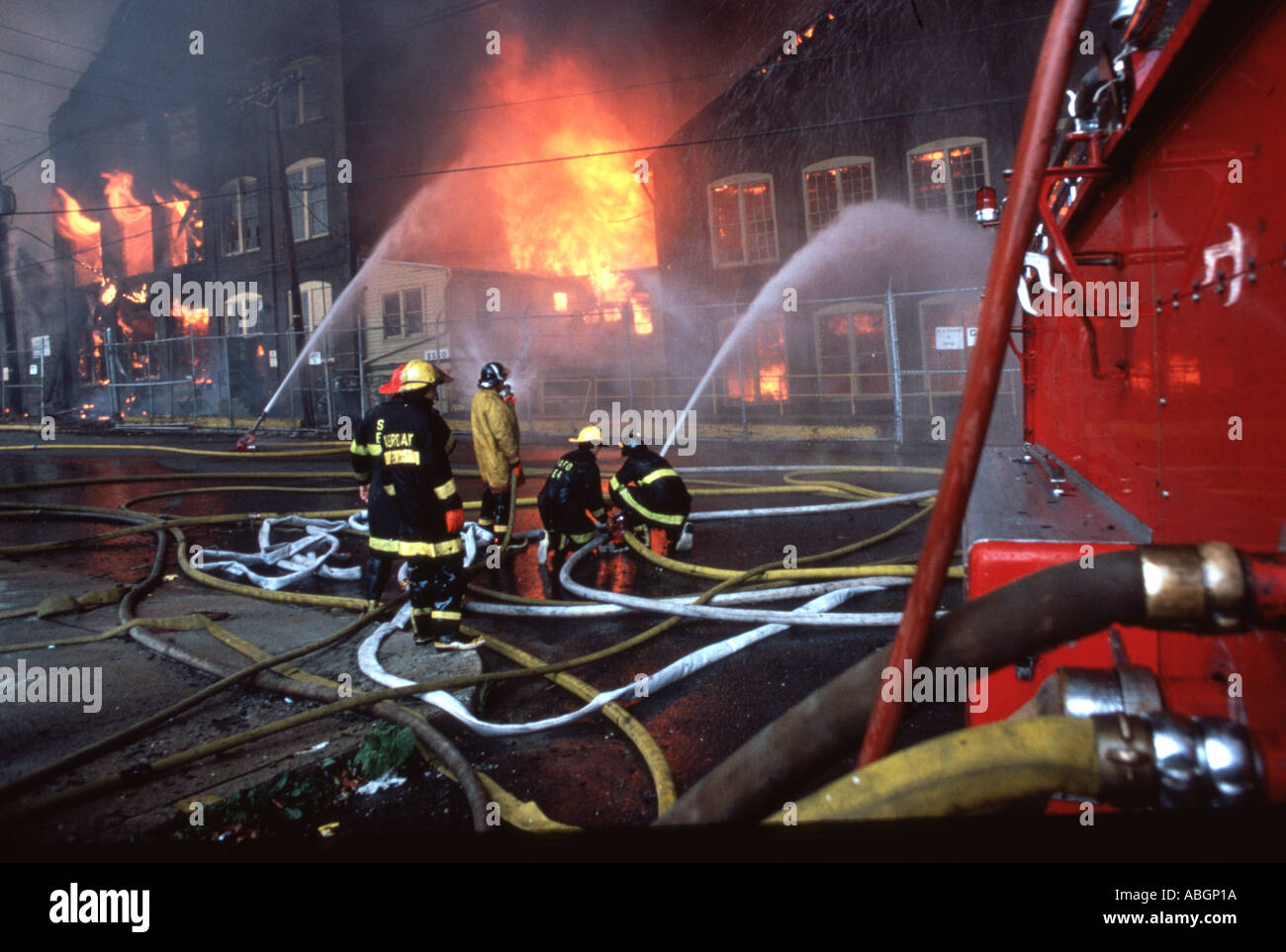 firemen fighting a factory fire Stock Photo - Alamy