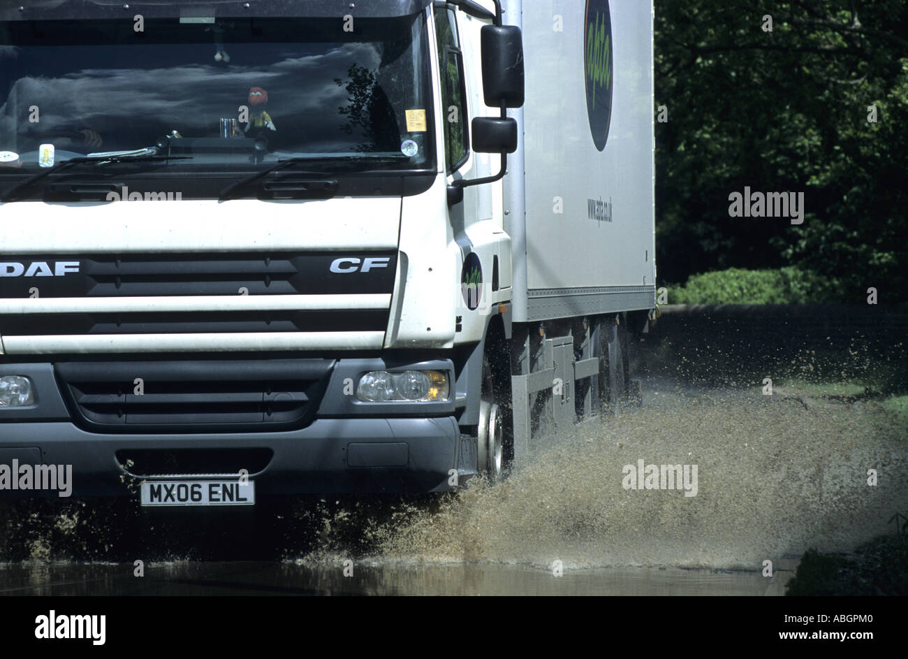 Lorry splashing through flood on road, Warwickshire, England, UK Stock ...
