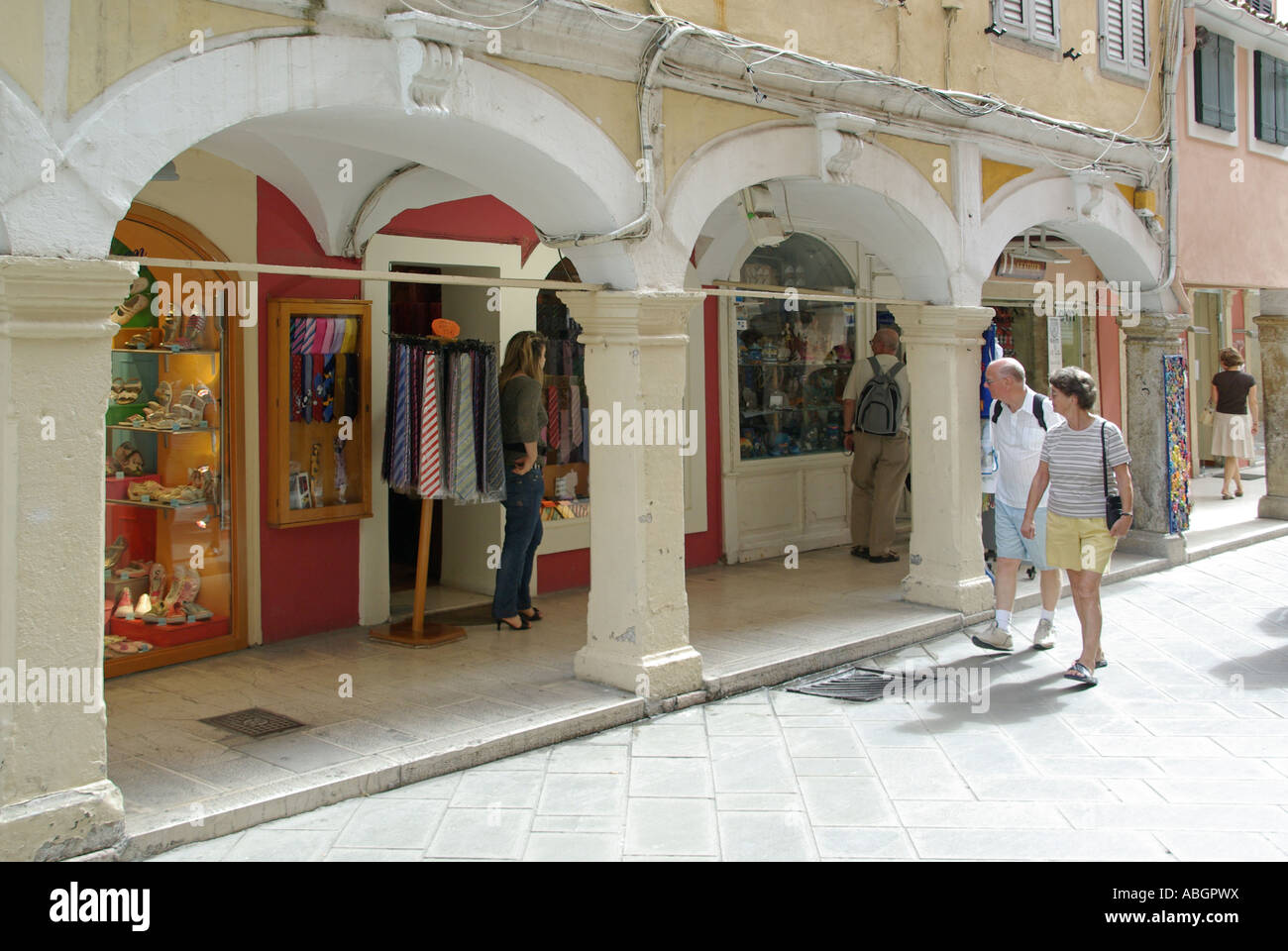 Corfu Town Greek arcade shops & couple walking in mainly traffic free ...