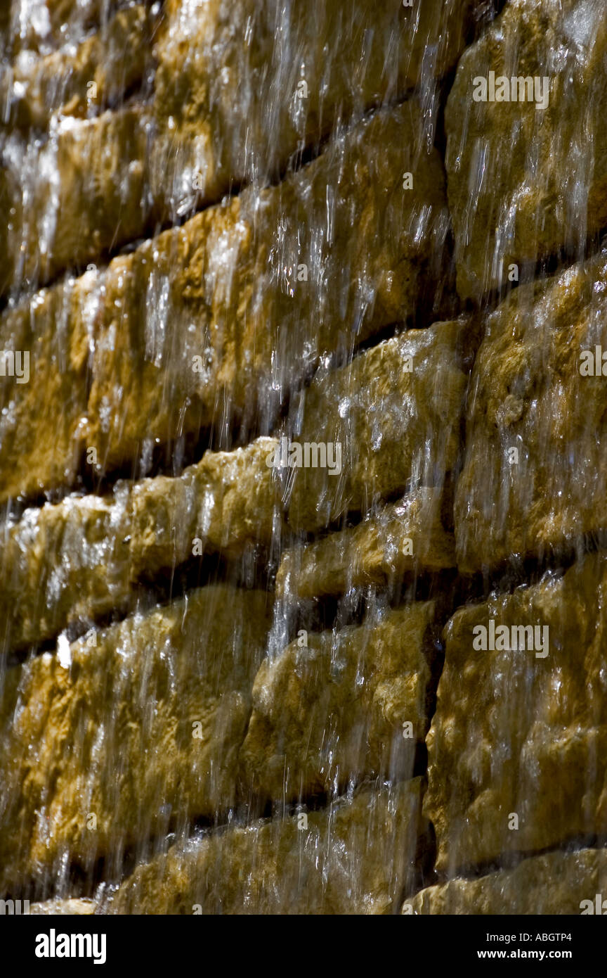 Water falling over rock wall Stock Photo - Alamy