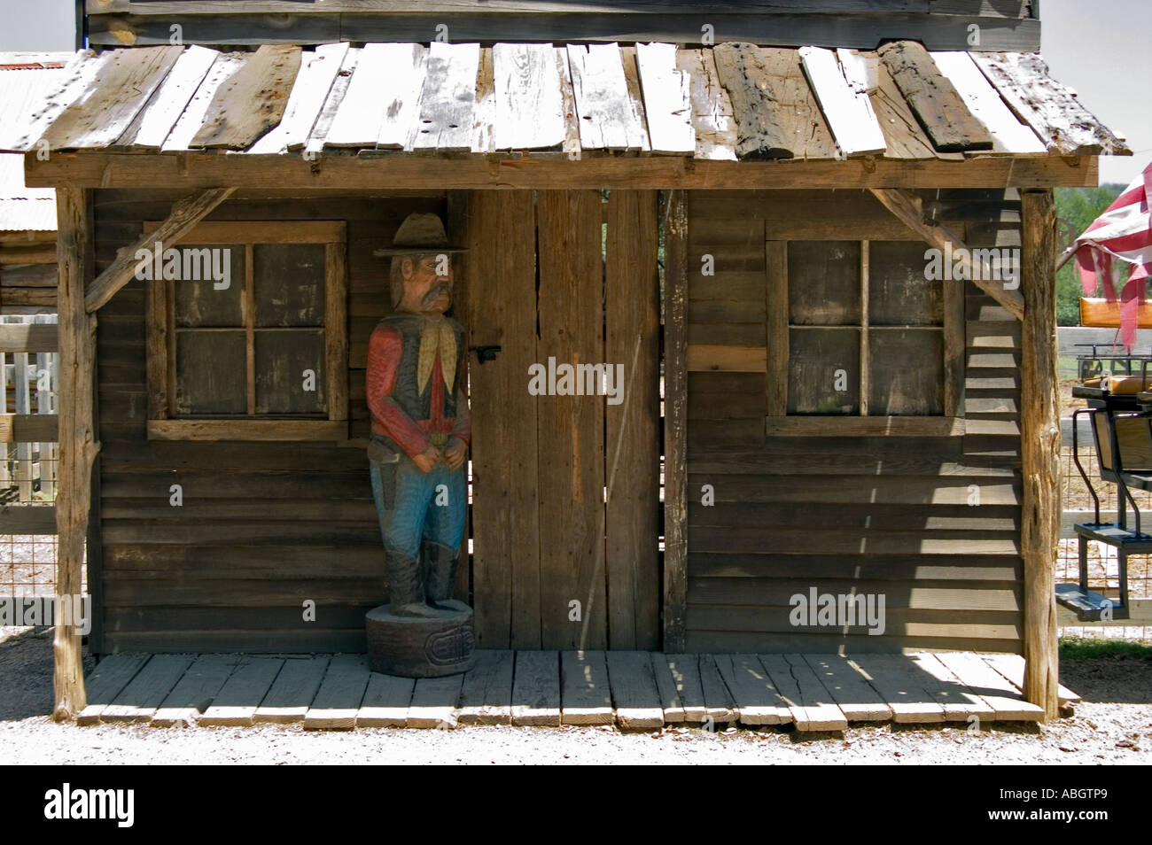Rustic house porch with wooden man Stock Photo - Alamy