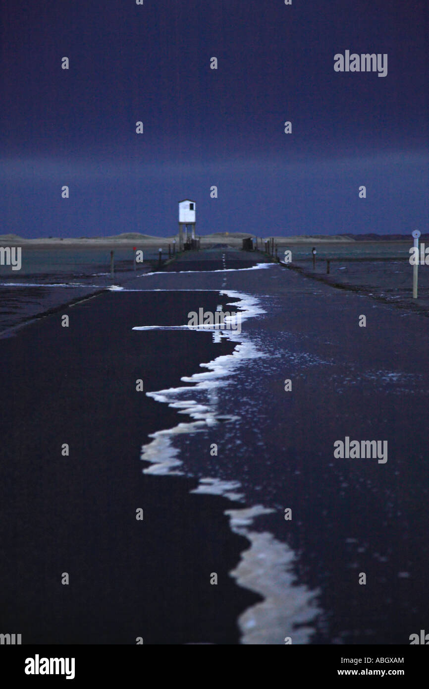 The tide is coming in over the causeway to Lindisfarne Northumberland ...