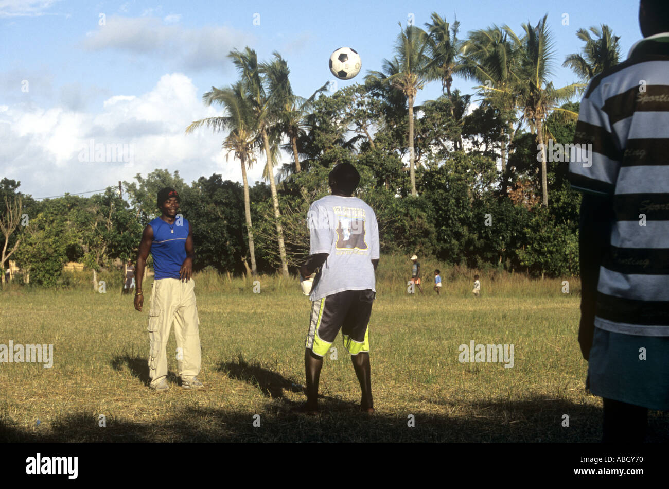 Three boys practicing soccer or football on Inhaca Island in bay of ...