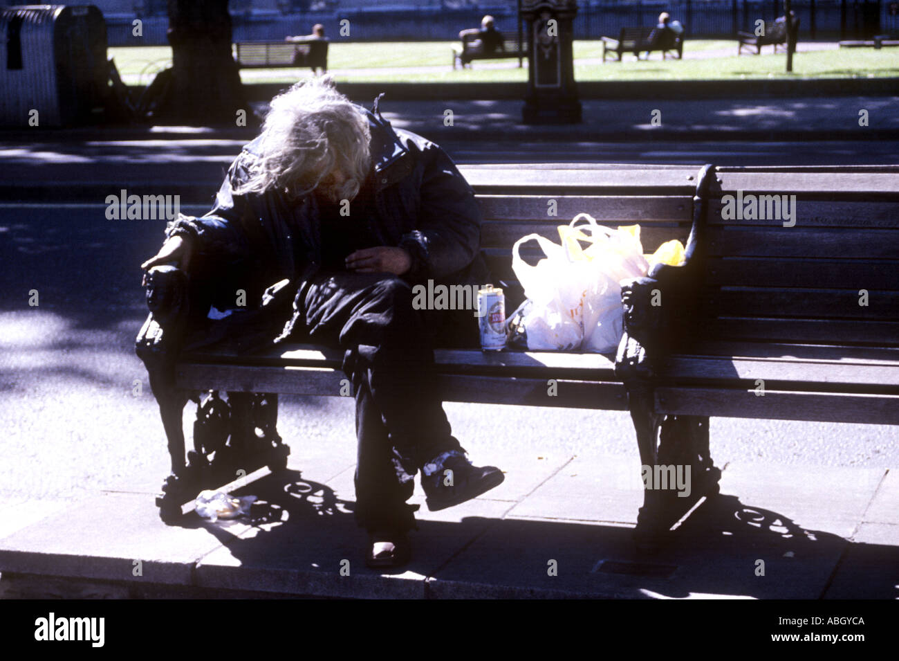 Homeless man with can of beer and his few belongings on Embankment ...