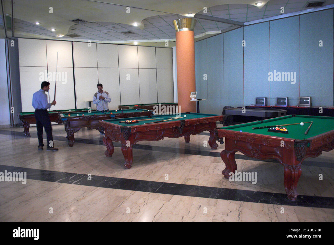 Two men playing pool in games area of entrance lobby to ...