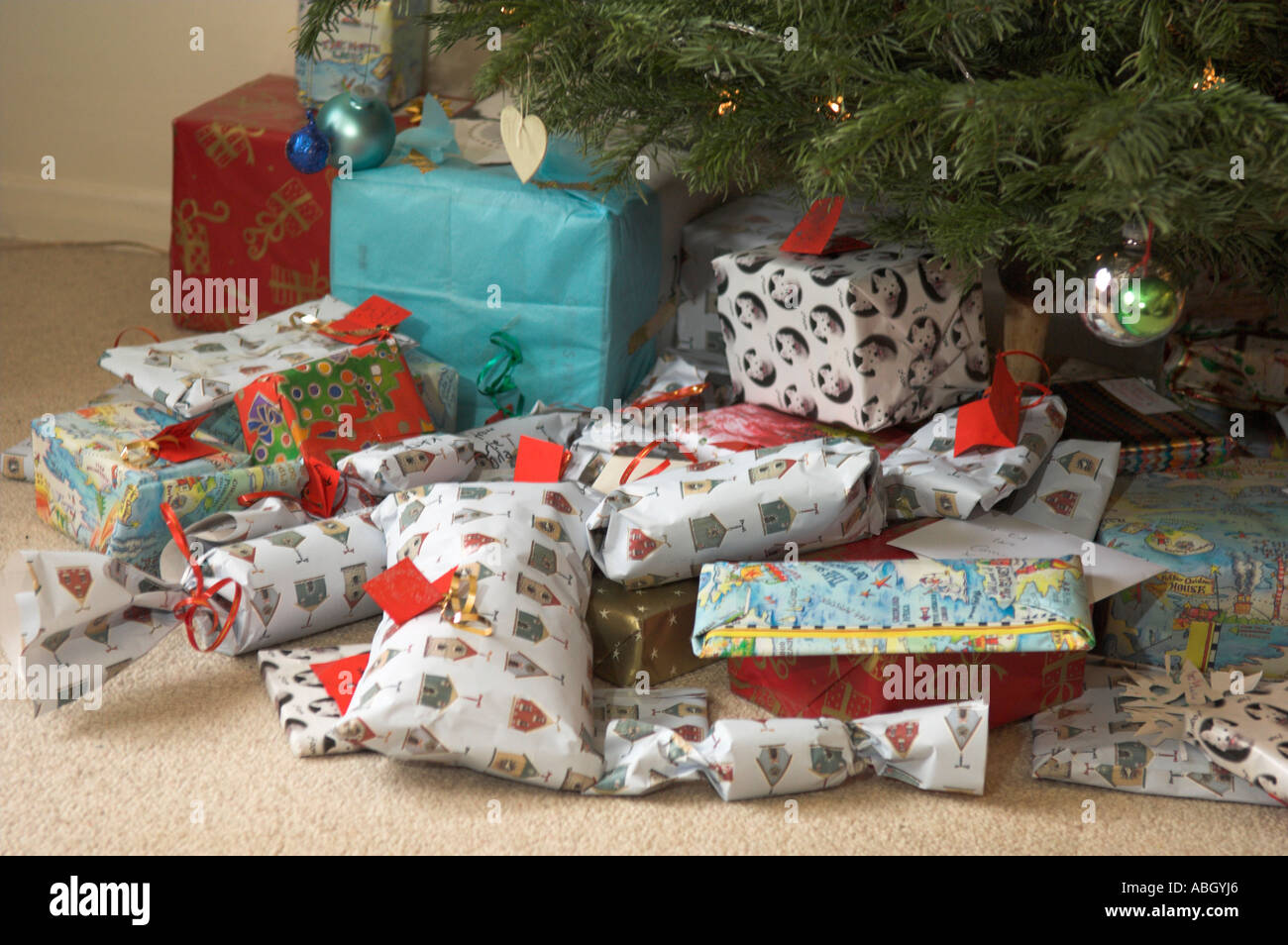 Christmas presents under tree with lights and presents Stock Photo - Alamy