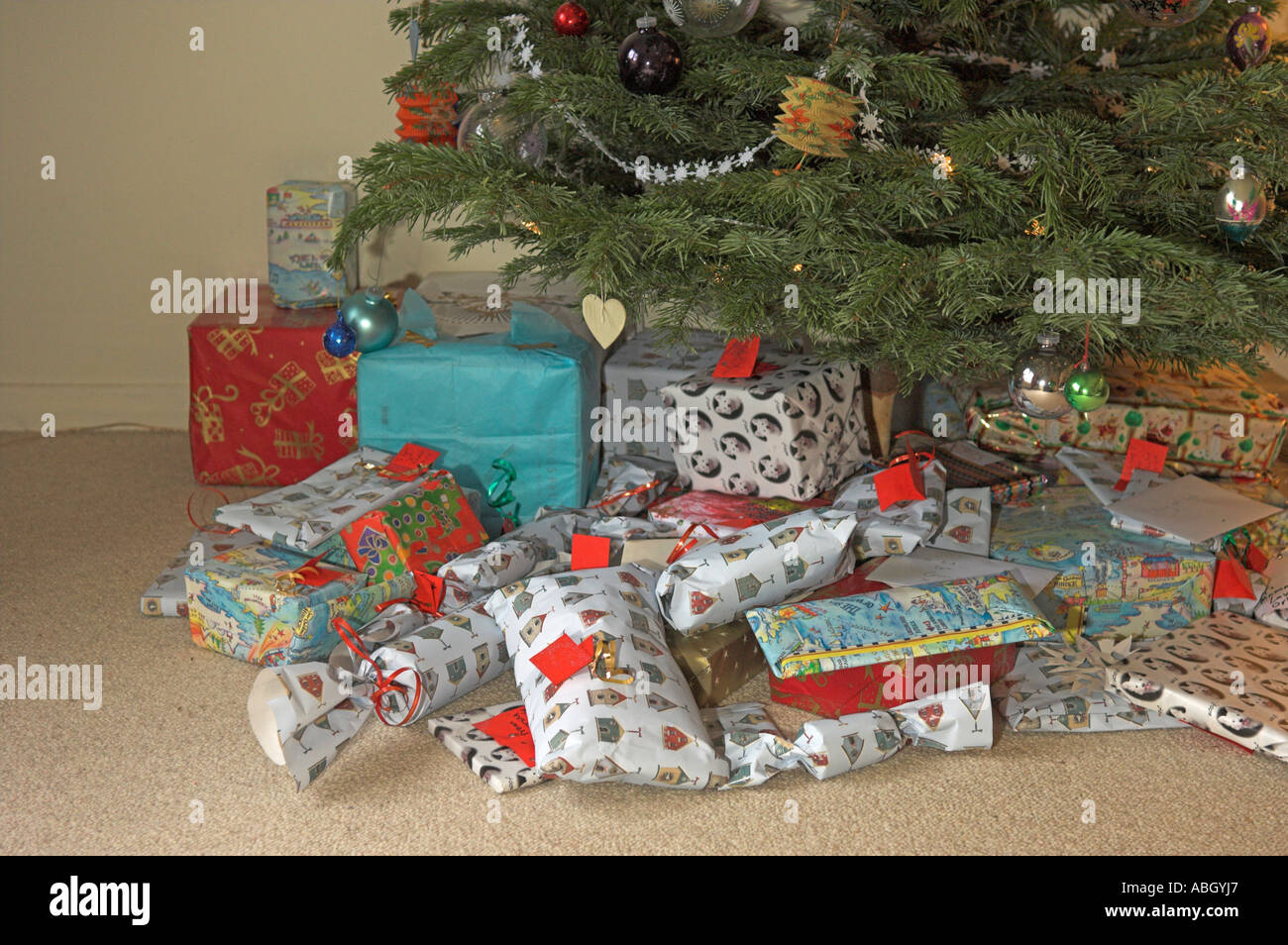 Christmas presents under tree with lights and presents Stock Photo - Alamy
