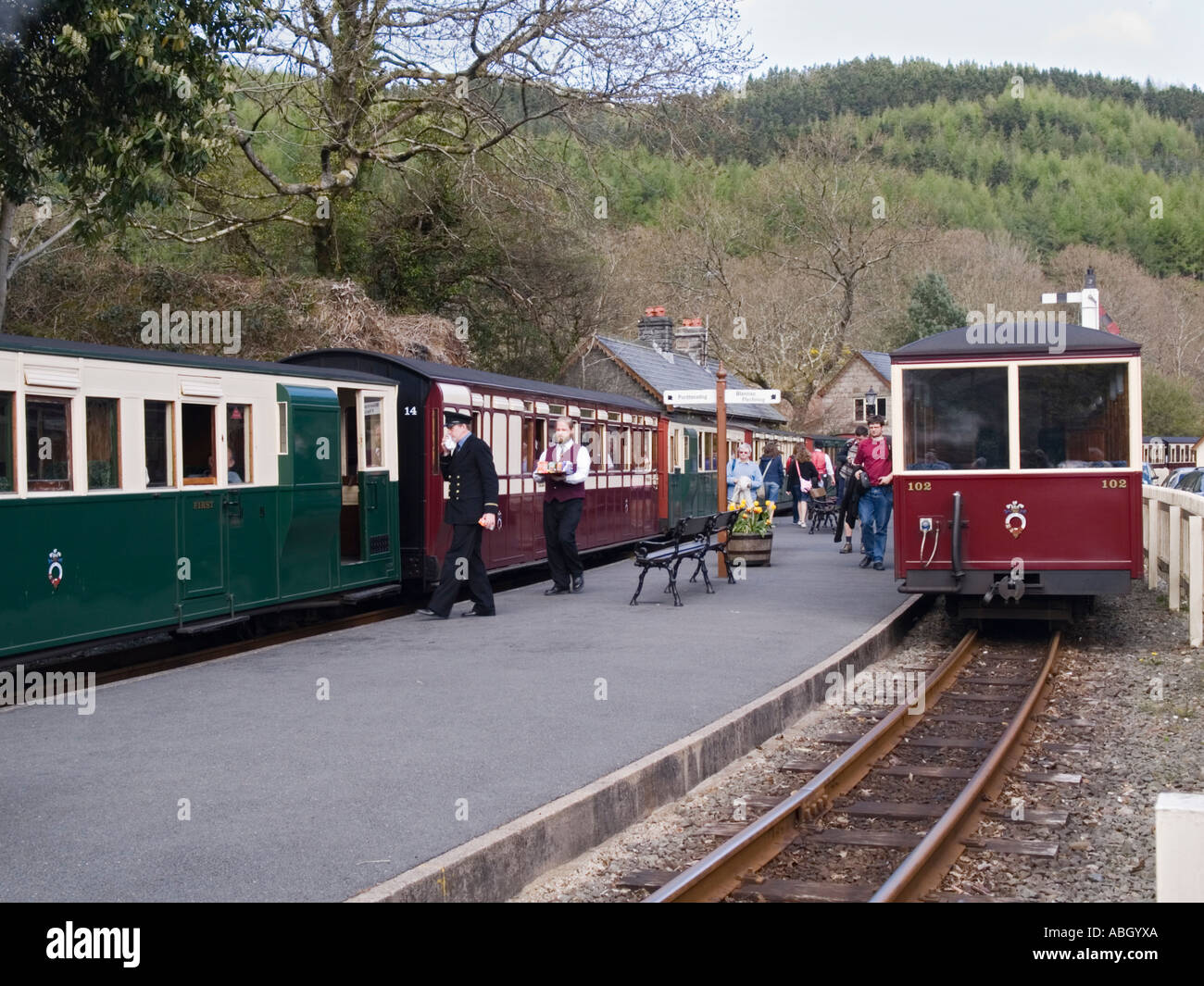 Restored steam train carriages in Tan-y-Bwlch station with passengers boarding on heritage ...