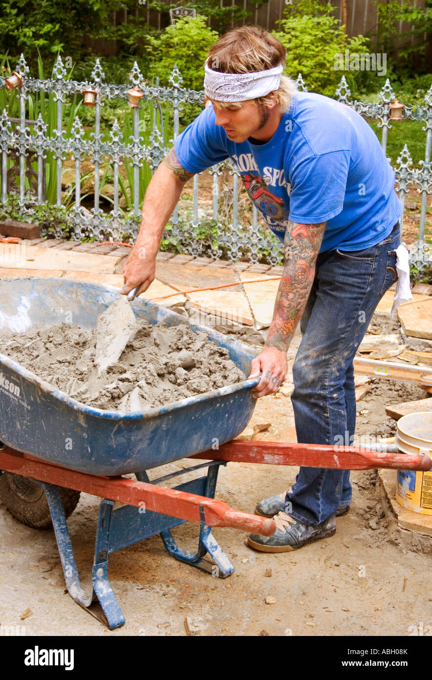 Male stonemason mixing cement Stock Photo - Alamy