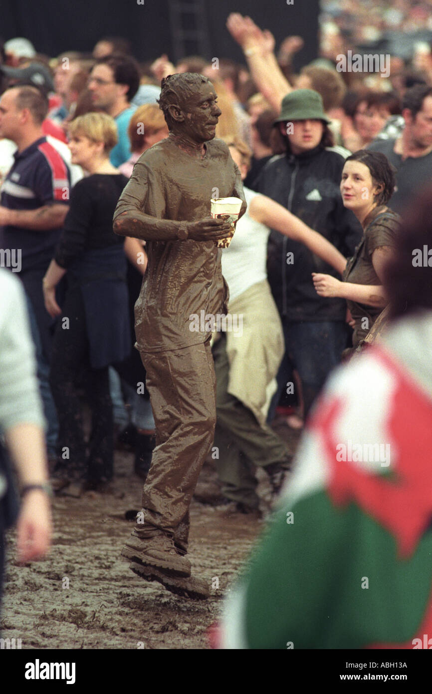 Pop fan dancing covered in mud at a music festival UK Stock Photo - Alamy