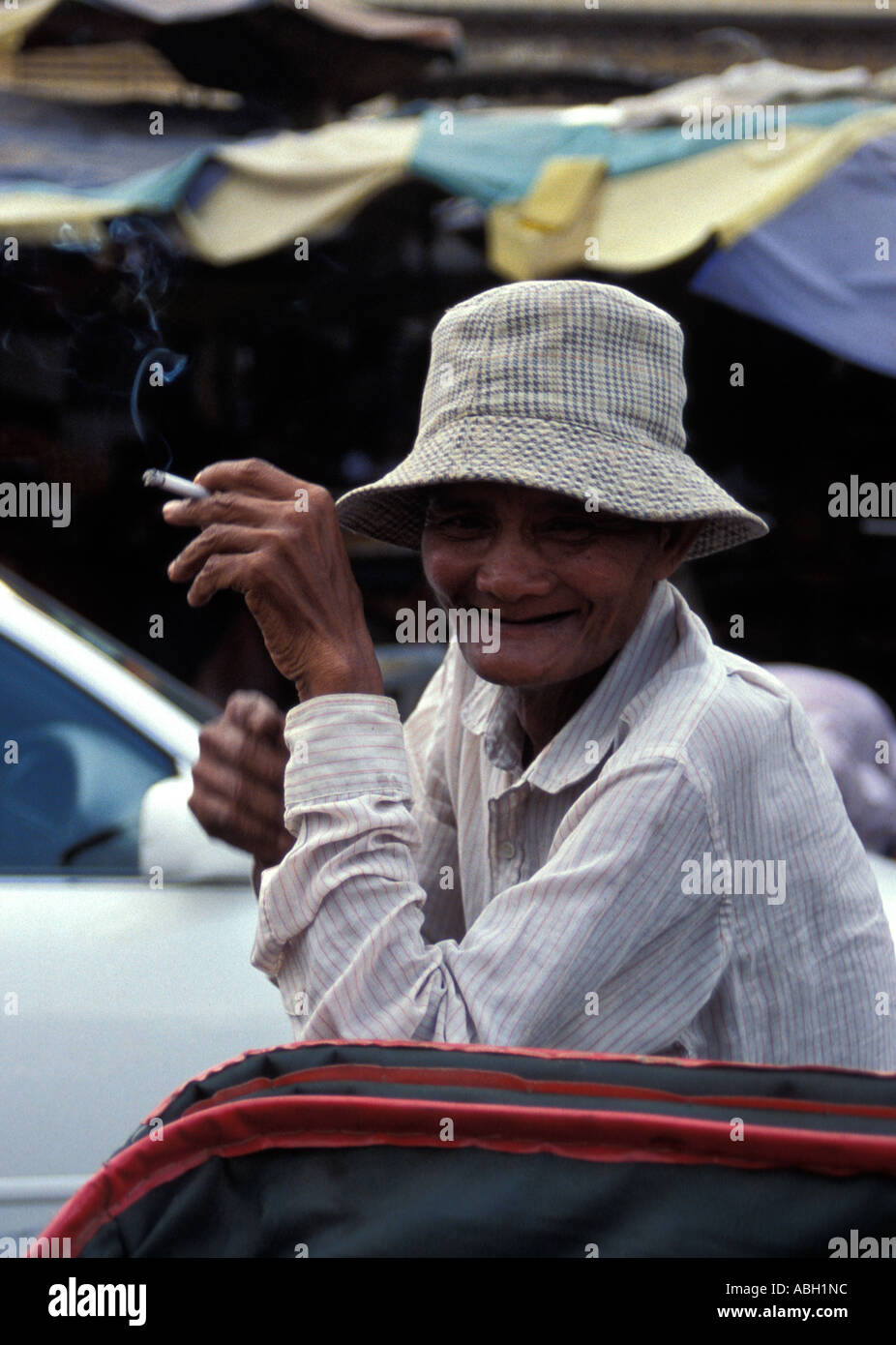 Cyclo driver smoking cigarette, Phnom Penh, Cambodia Stock Photo - Alamy
