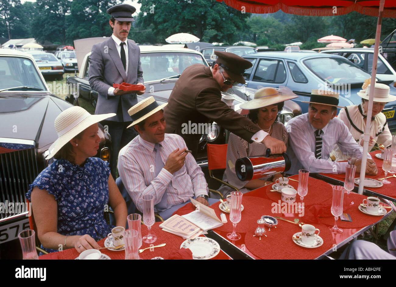 Picnic 1980s Uk Rich poor social divide, chauffeurs waiting on table ...