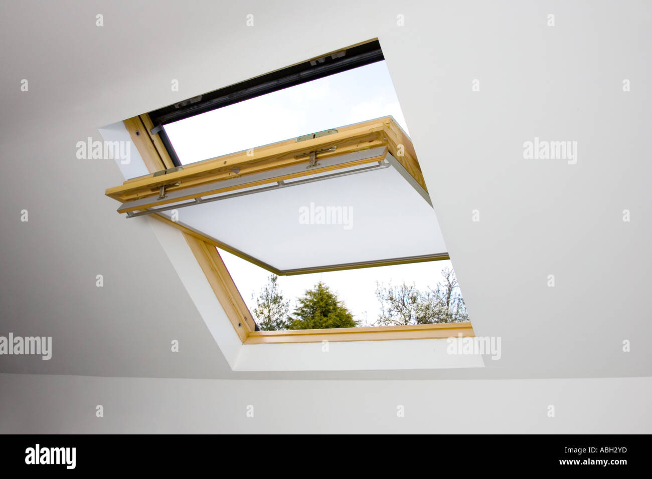 Velux roof window half open, with fabric roller blind Stock Photo - Alamy