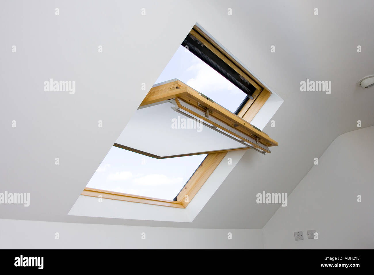 Velux roof window half open, with fabric roller blind Stock Photo - Alamy