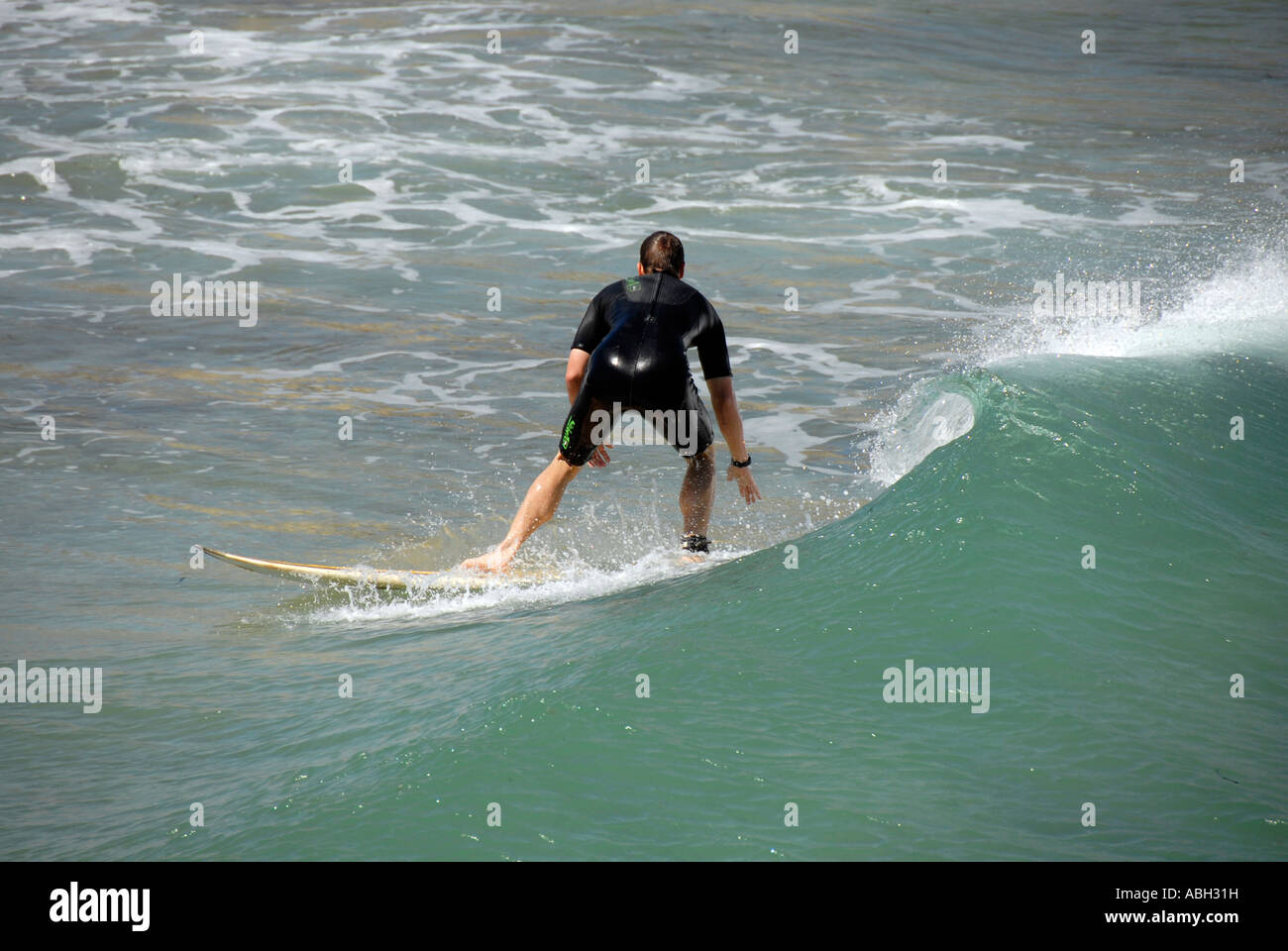 Young man surfing Stock Photo - Alamy