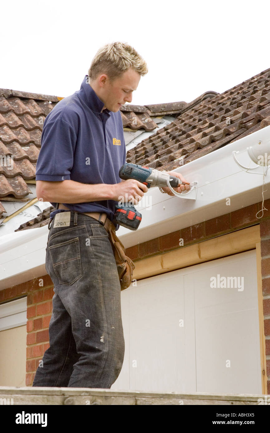 Builder installing brackets hold gutter hi-res stock photography and ...