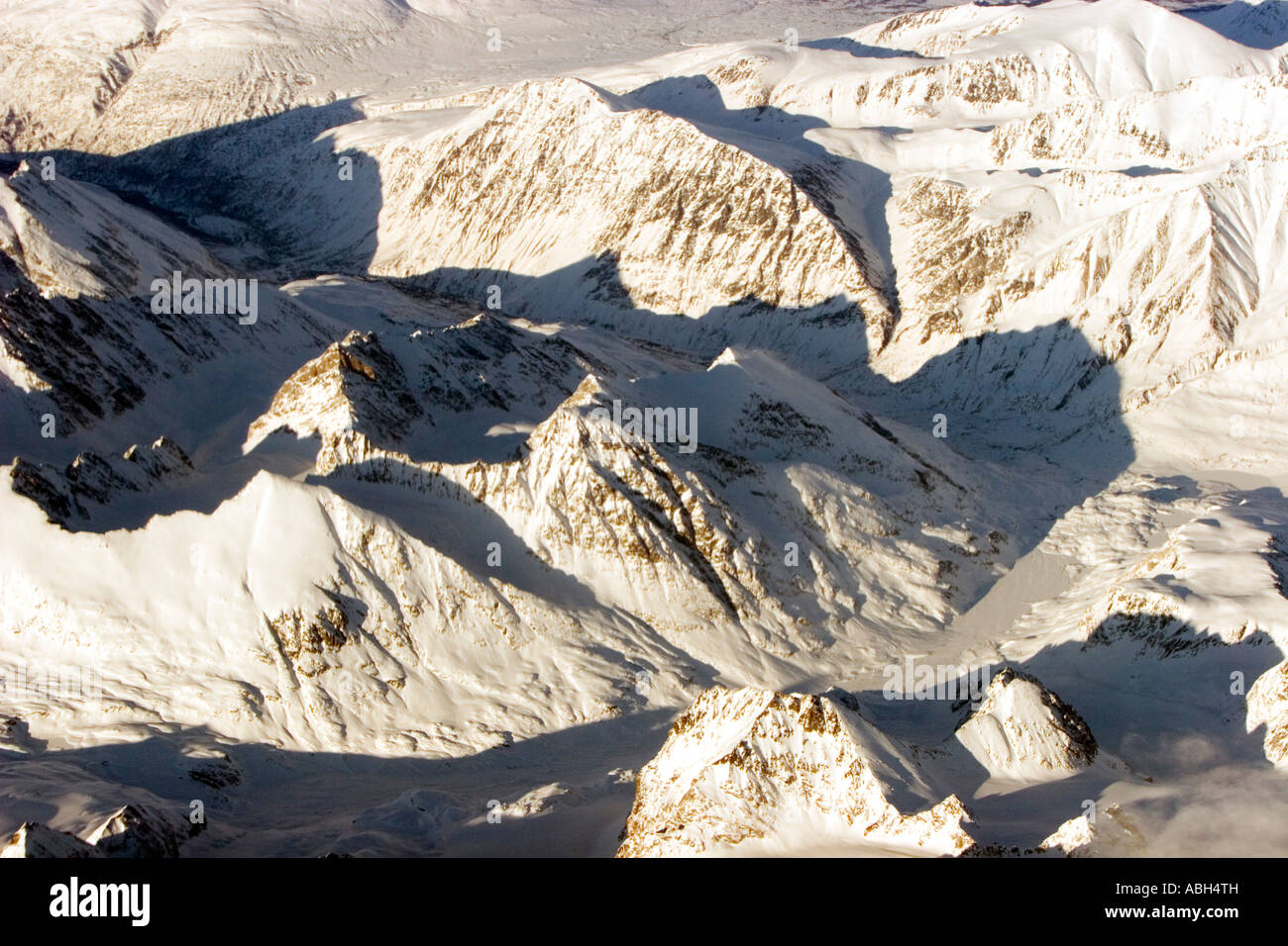 Snow covered mountains and glacial valleys aerial view of winter Alaska ...