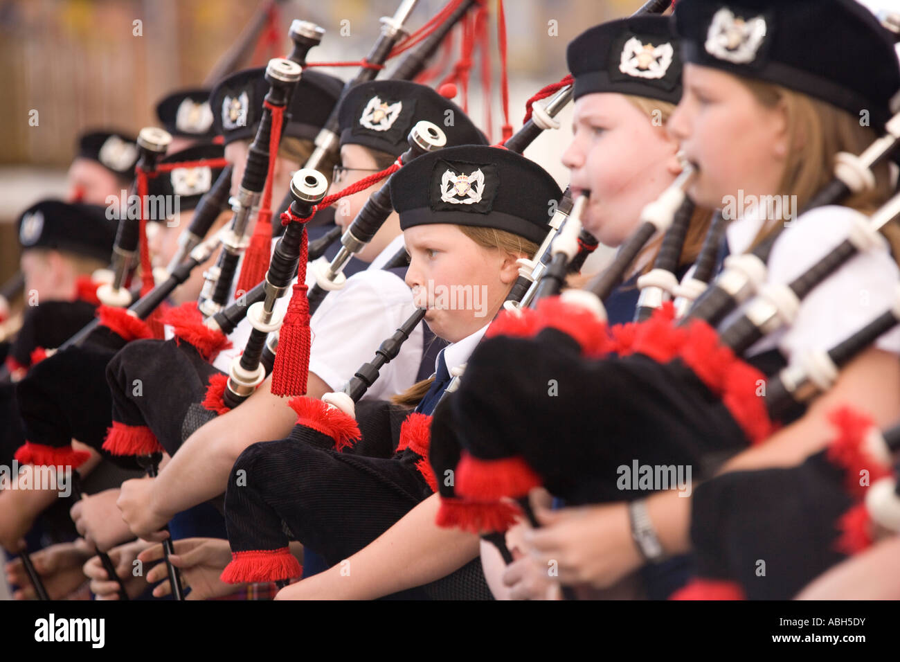 Pipe band young kids playing the bagpipes on Annan High Street part of ...
