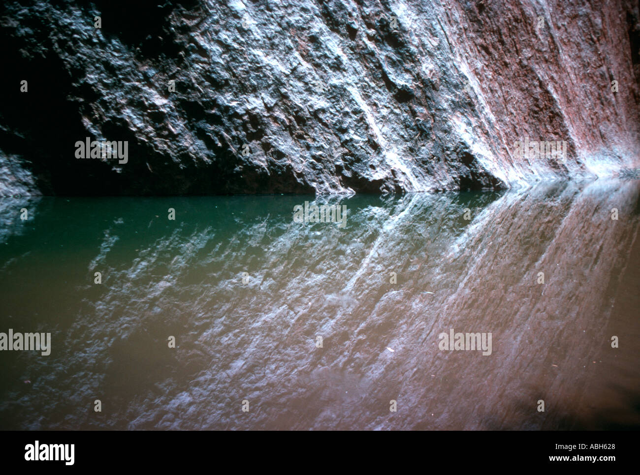 Reflection of the monolith in a puddle at the base of Ayers Rock, Ulure ...
