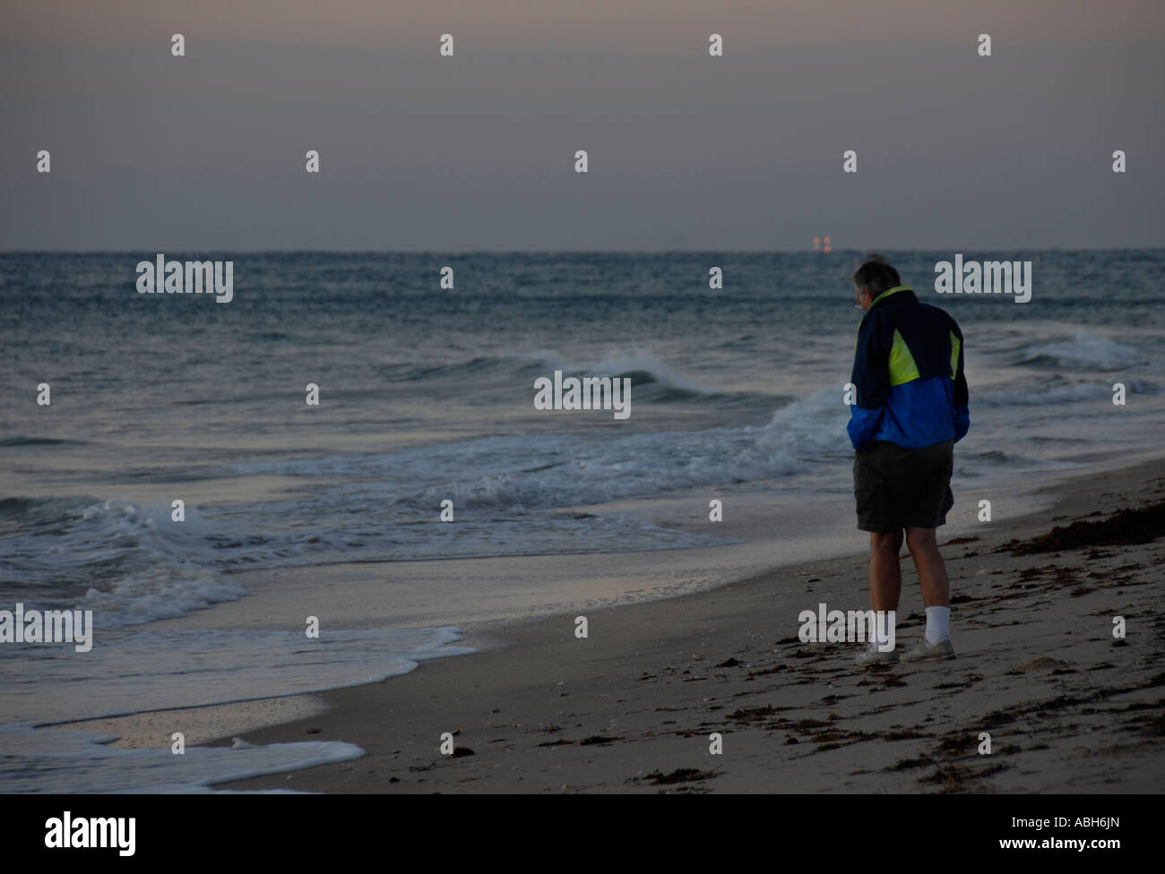 Lone man on the beach Stock Photo - Alamy