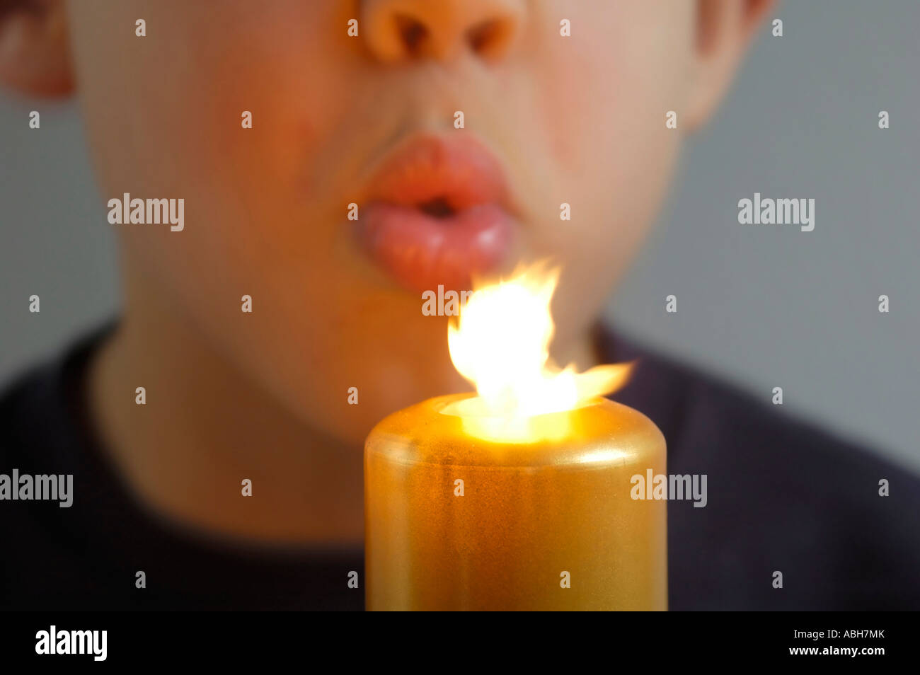 Child blows out a candle Stock Photo - Alamy