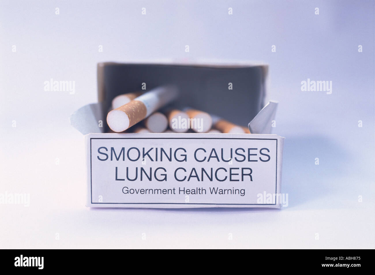 open cigarette packet showing health warning smoking causes lung cancer ...