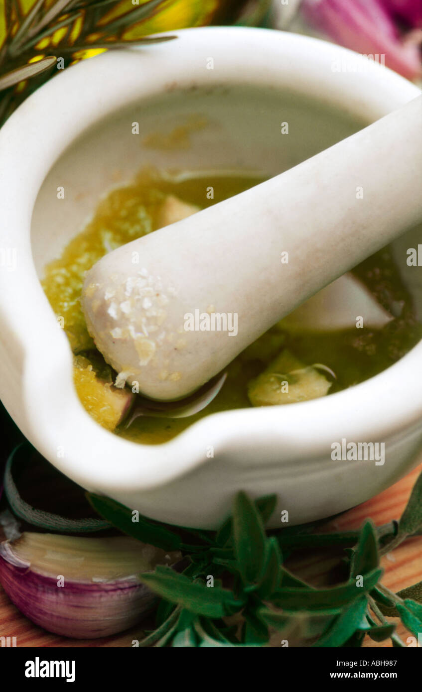 Making garlic dressing in pestle with mortar Stock Photo - Alamy