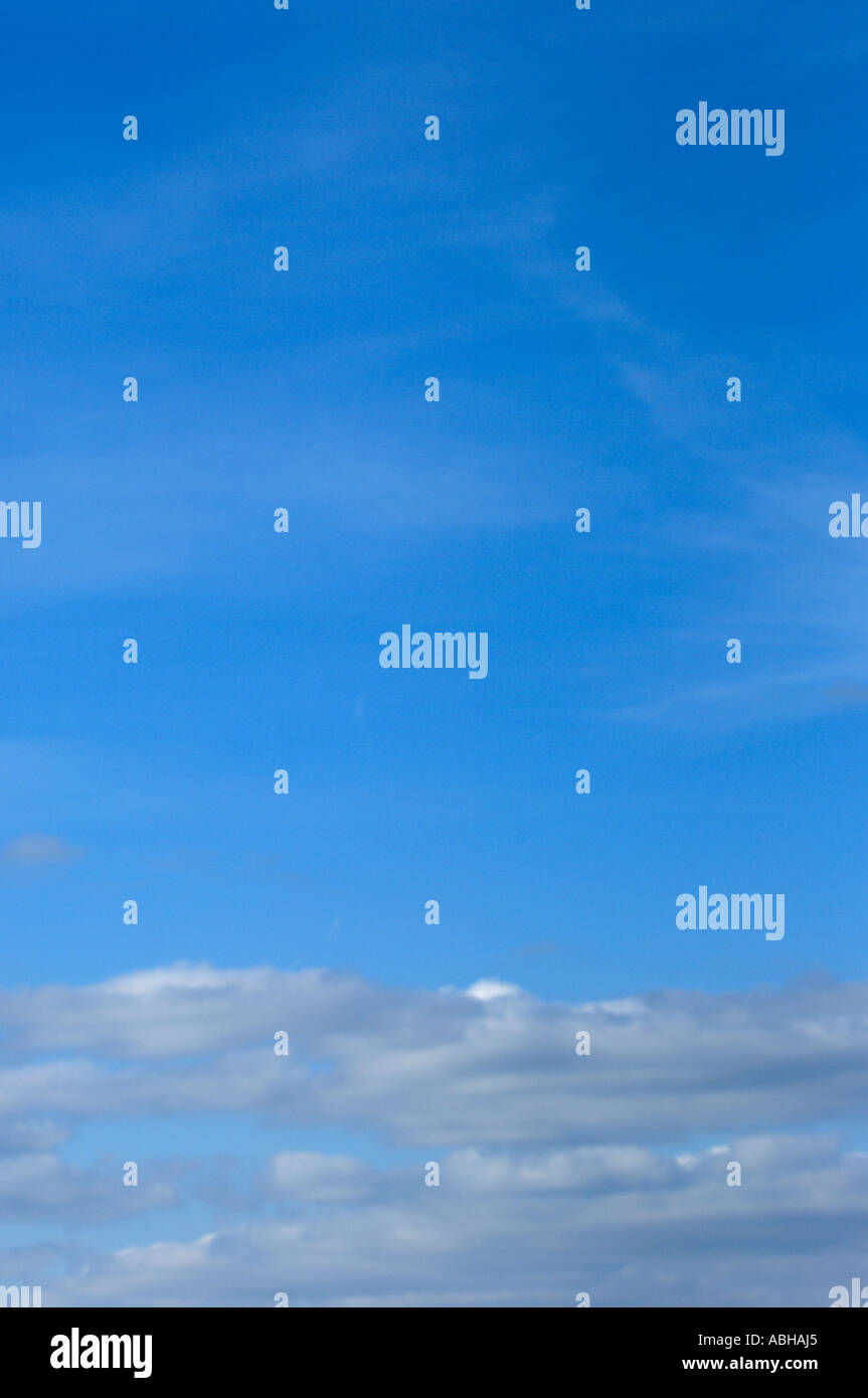 Bright sunny saturated blue sky with fluffy clouds Stock Photo - Alamy