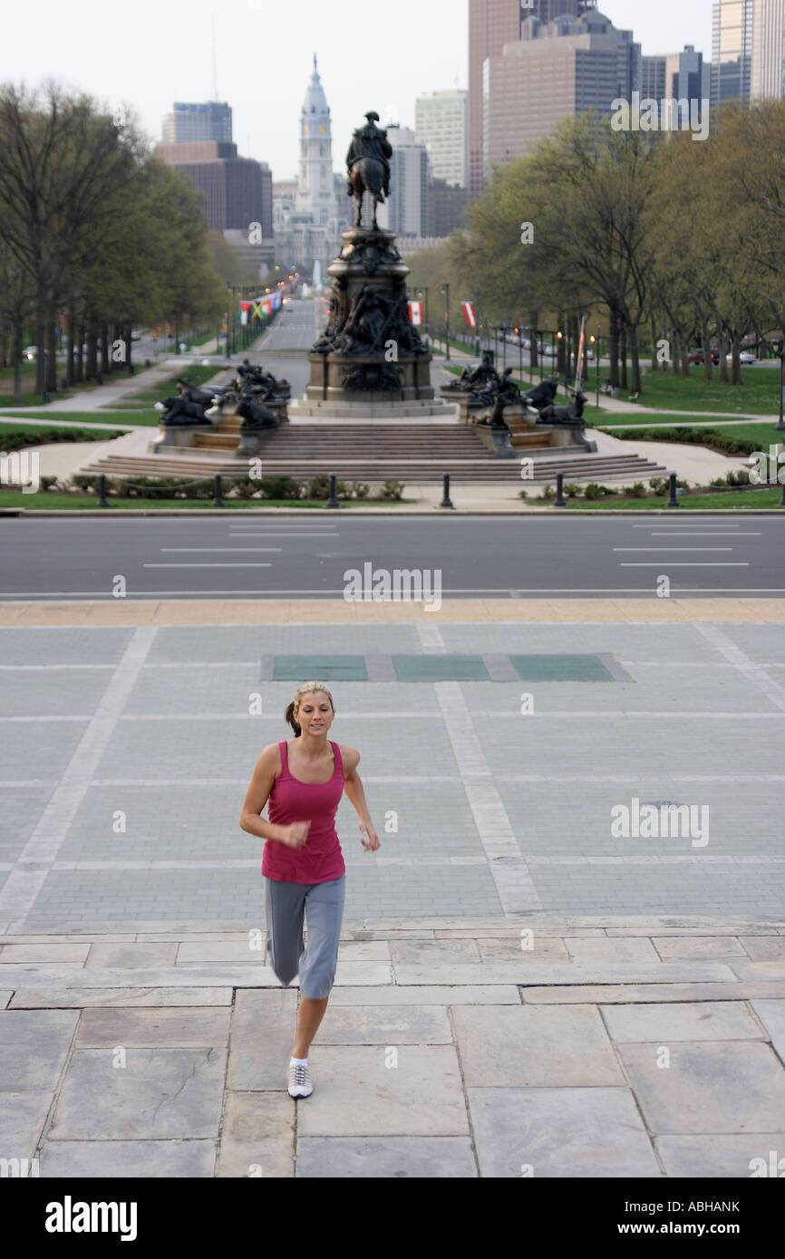 woman running on steps of art museum Stock Photo - Alamy