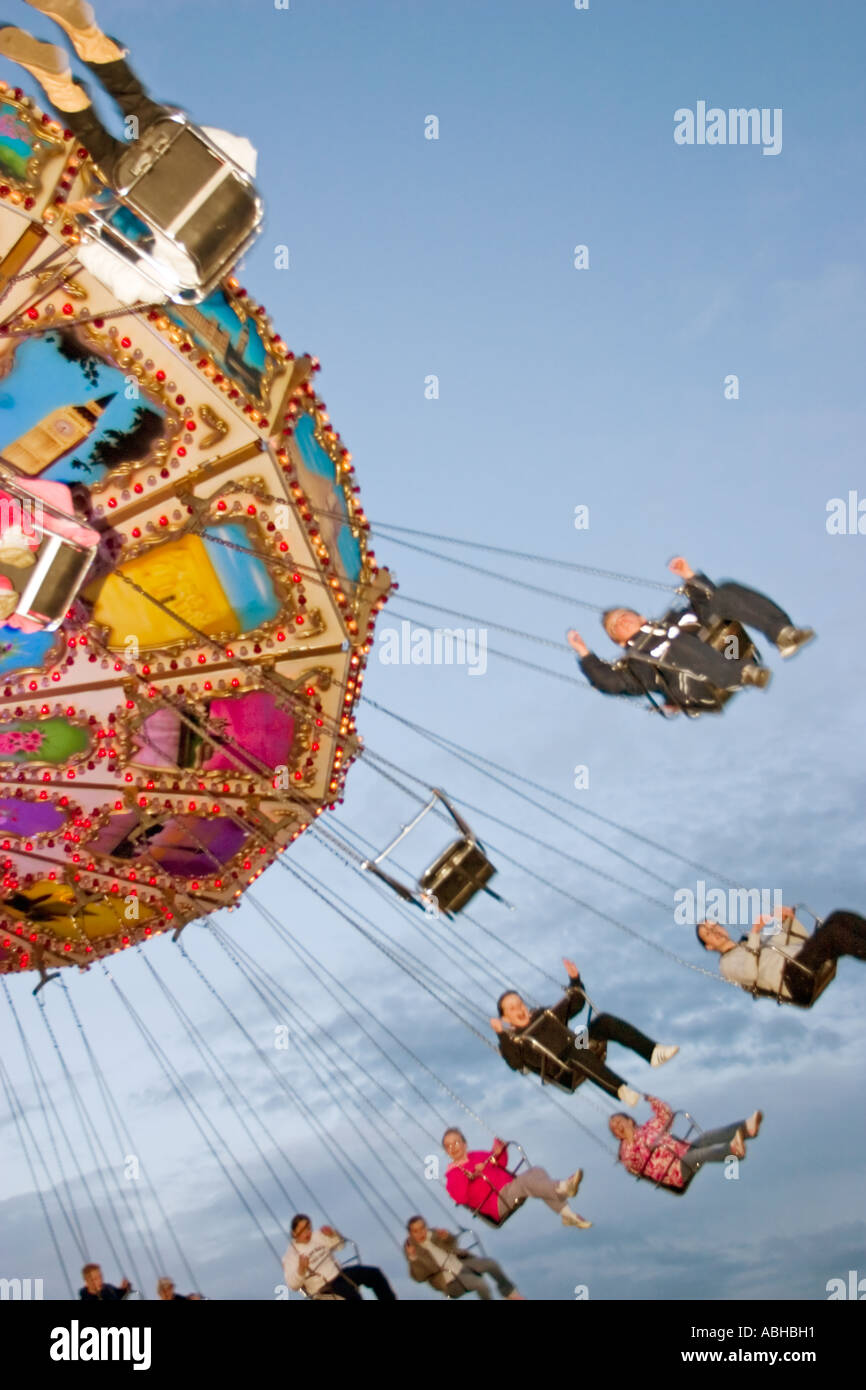 Spinning merrygoround carousel chairs Stock Photo - Alamy