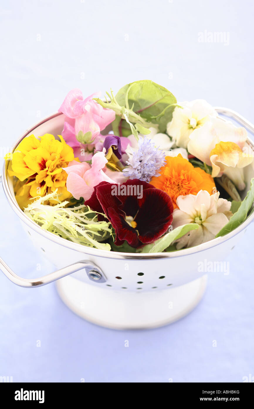 Colander full of edible flower salad Stock Photo - Alamy