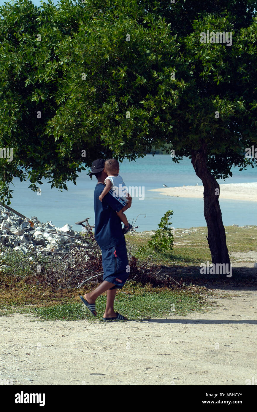 Man holding a young boy and walking on a beach Stock Photo - Alamy