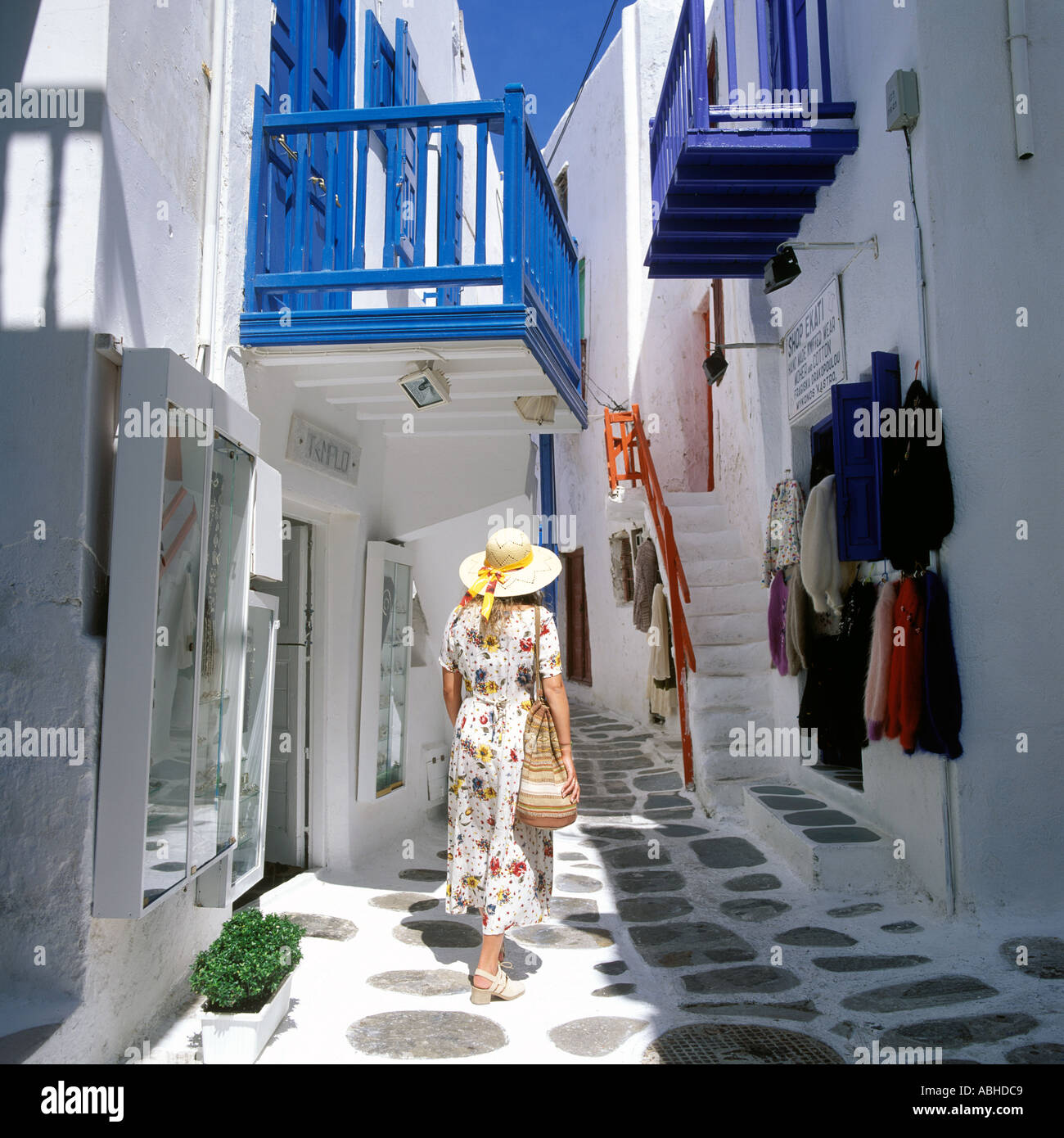 WOMAN WALKING IN TOWN STREET MYKONOS GREECE Stock Photo - Alamy