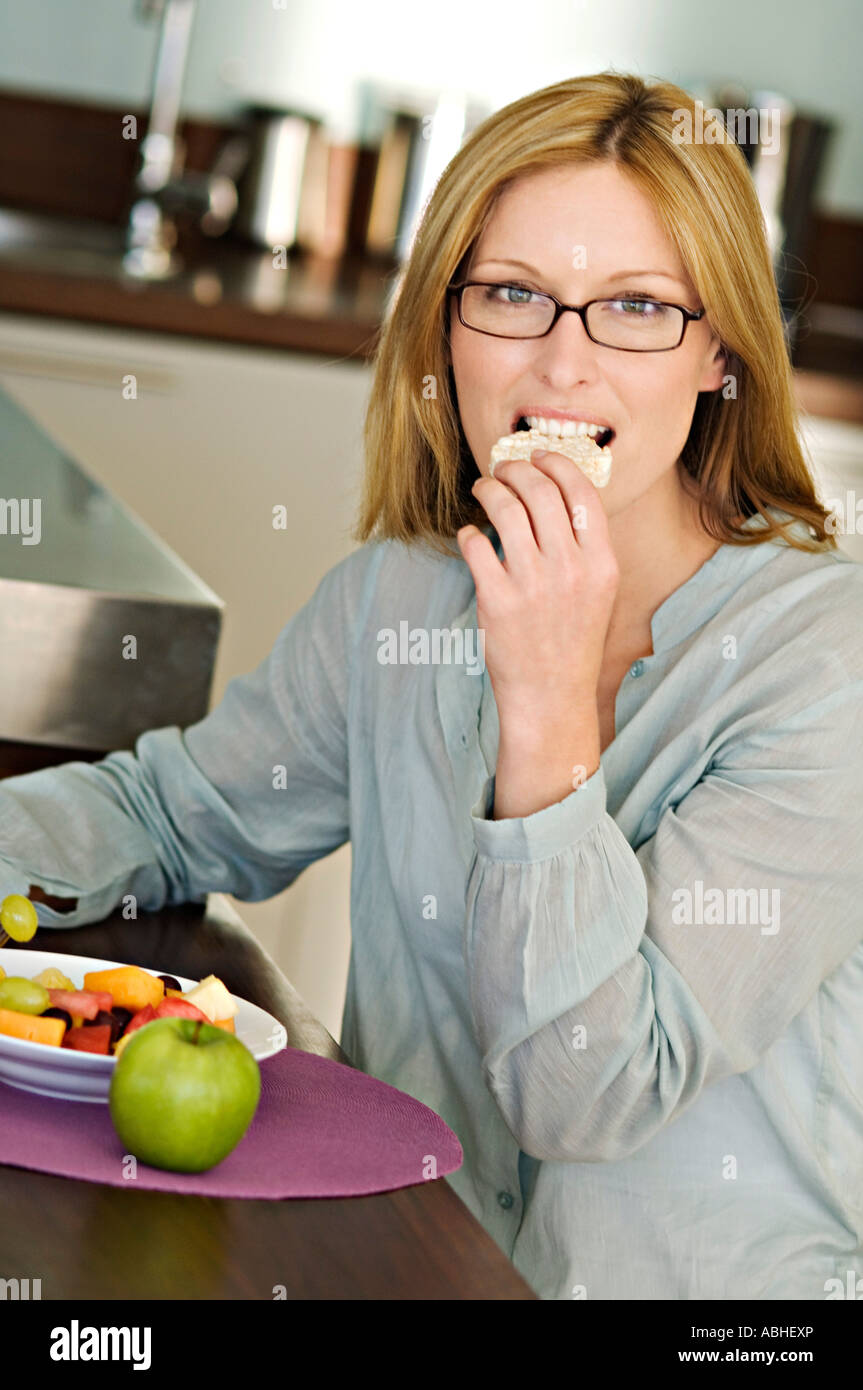 Woman eating rice cake Stock Photo - Alamy