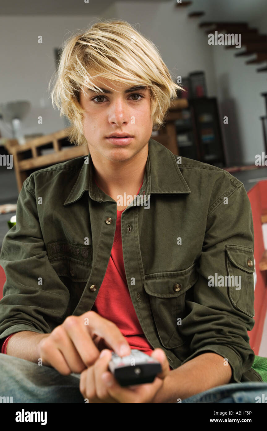 Teenage boy using remote-control Stock Photo - Alamy