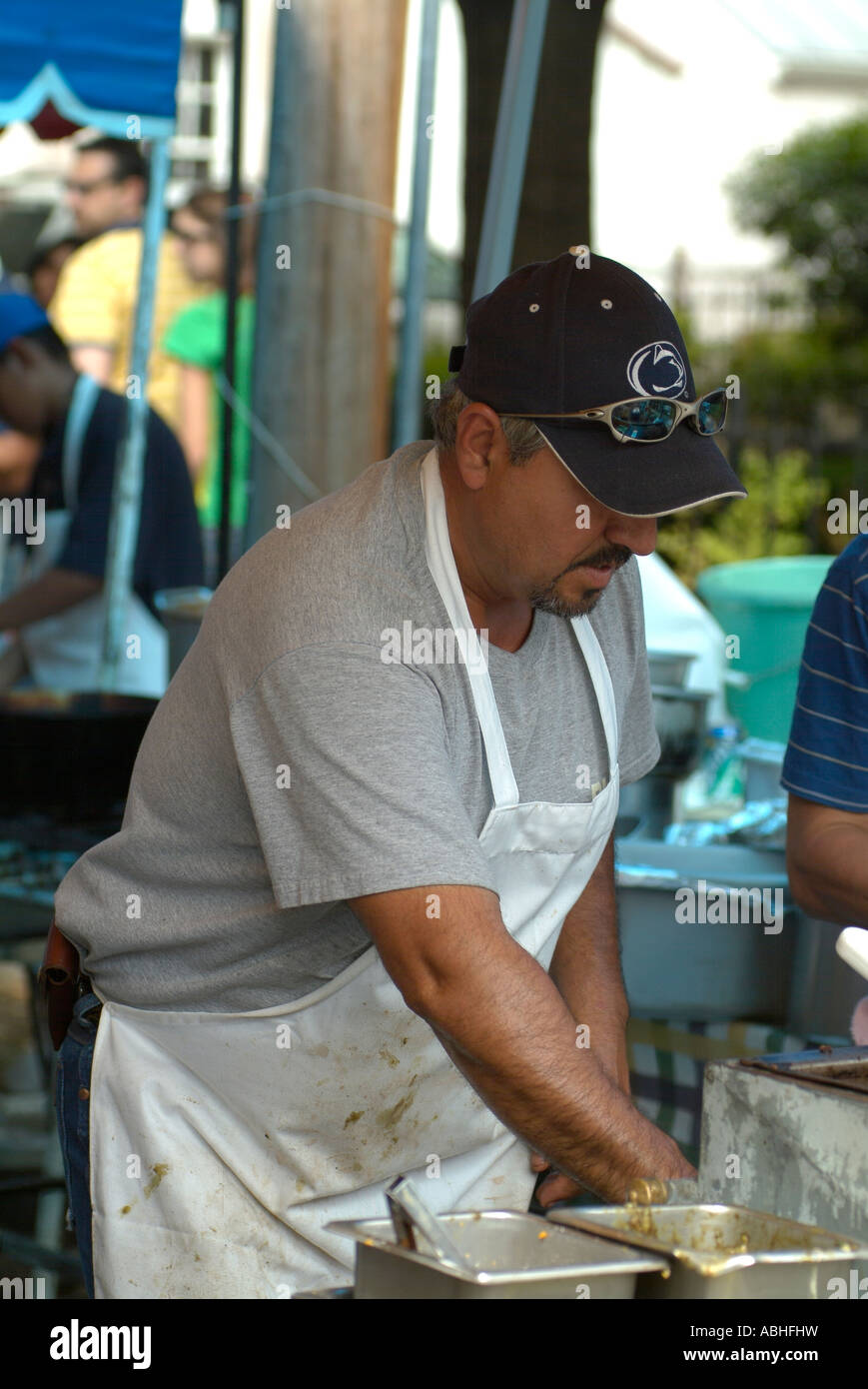 Cooks preparing food in a booth during a feast in San Antonio Stock ...