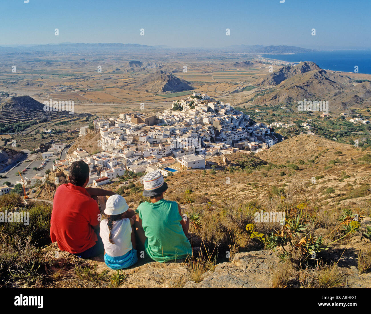 Mojacar, Almeria Province, Spain. Man and two children admiring overall ...