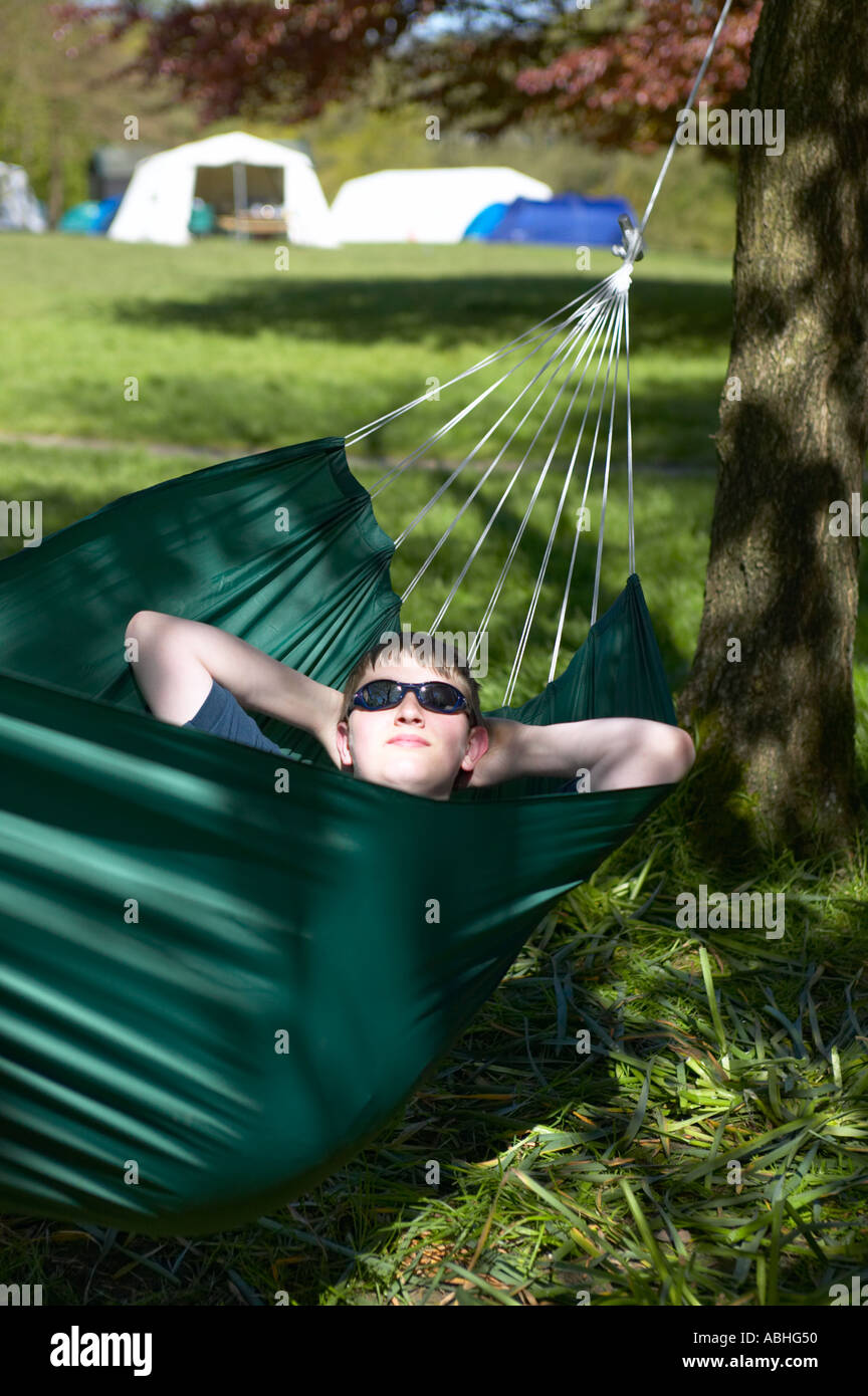 Young scout lounging in hammock Stock Photo - Alamy